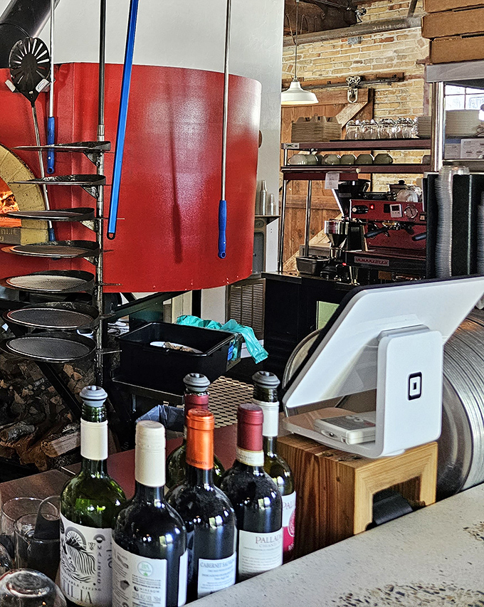 Where pizza magic happens. The gleaming counter, stacked boxes, and that glorious red oven in the background&mdash;this is pizza headquarters.