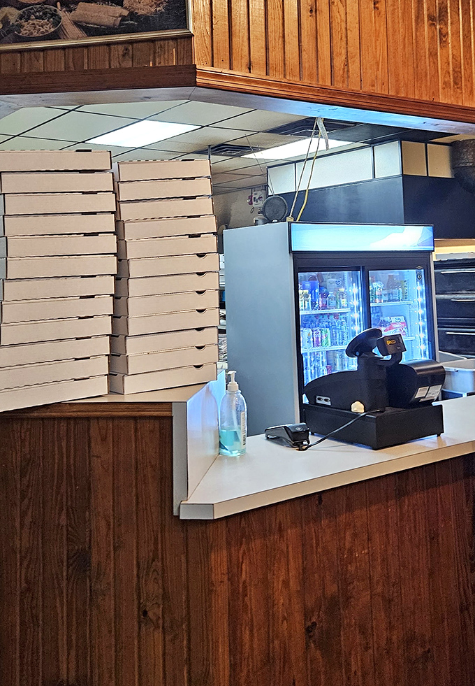 Pizza boxes stacked like a carbohydrate skyline. Each one contains someone's perfect night in&mdash;no cooking, no cleanup, just pure enjoyment.