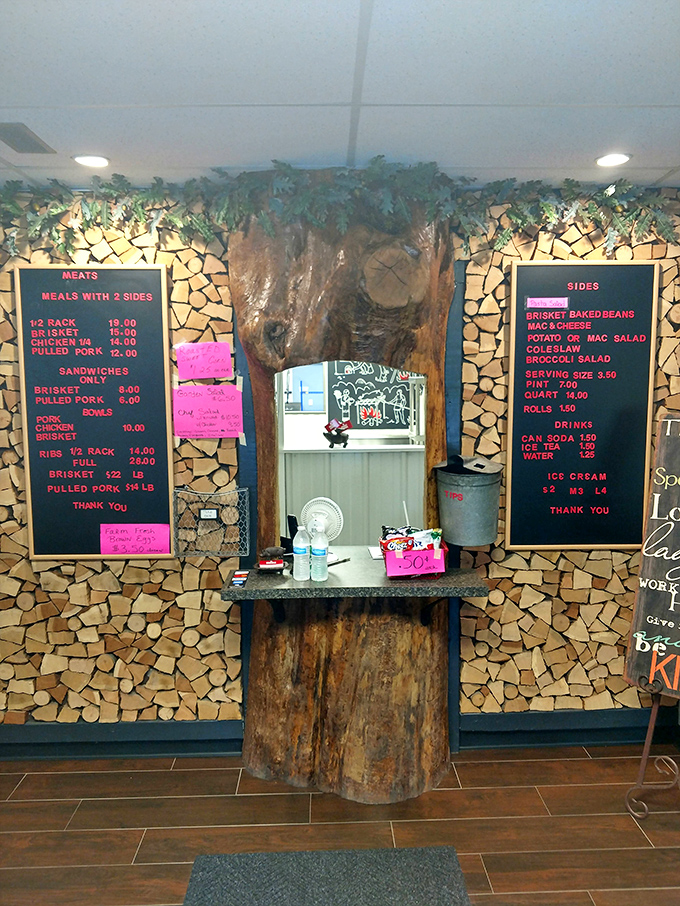 The ordering counter, where dreams come true and split firewood walls remind you that proper barbecue requires proper fuel.