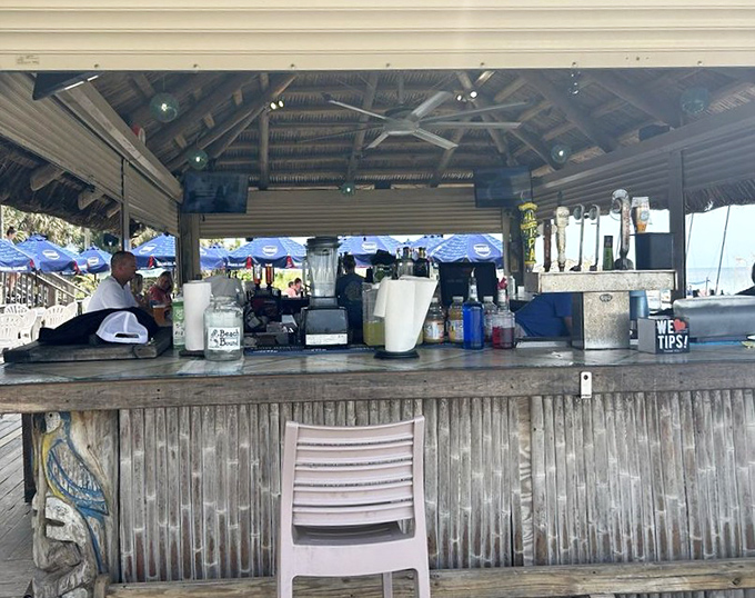 The tiki bar where vacation dreams come true. That "We &hearts; Tips!" sign isn't subtle, but neither is the ocean view behind it.