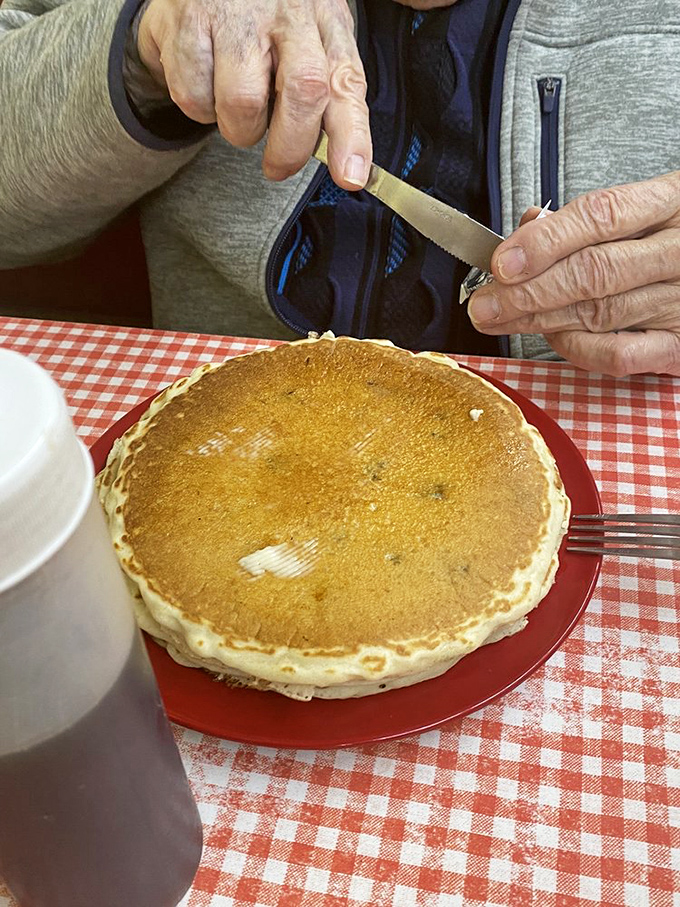 Someone's about to perform pancake surgery on this golden disc of happiness. The knife is poised for breakfast bliss!