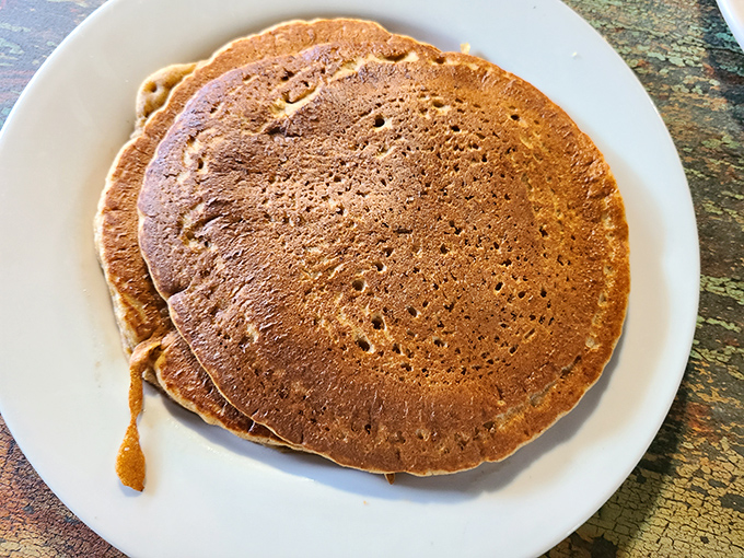 Pancakes stacked like edible frisbees, waiting to be drenched in syrup and devoured without shame or regret.