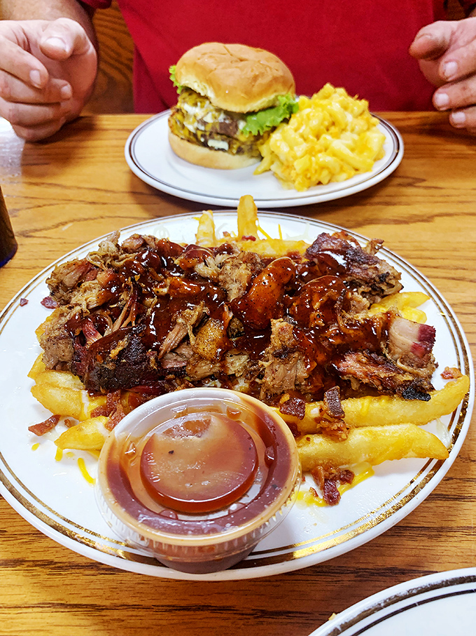 BBQ pulled pork fries&mdash;where comfort food has a family reunion. That burger in the background is experiencing serious FOMO.