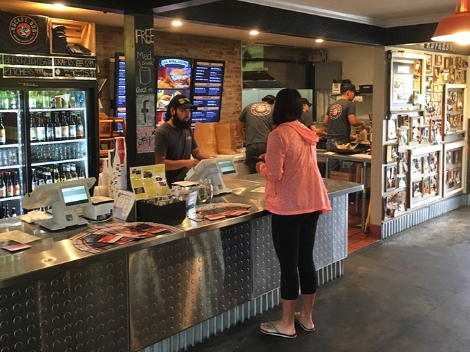 The command center where orders become edible happiness, with a wall of memories watching over every transaction.