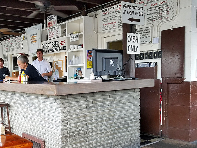 The register area proudly announces what locals already know: cash only, because some traditions are worth preserving.