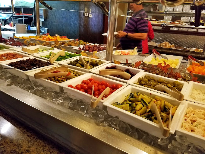 The salad bar&mdash;where good intentions meet reality. Fresh vegetables and prepared salads await those pretending they didn't come just for the crab legs.