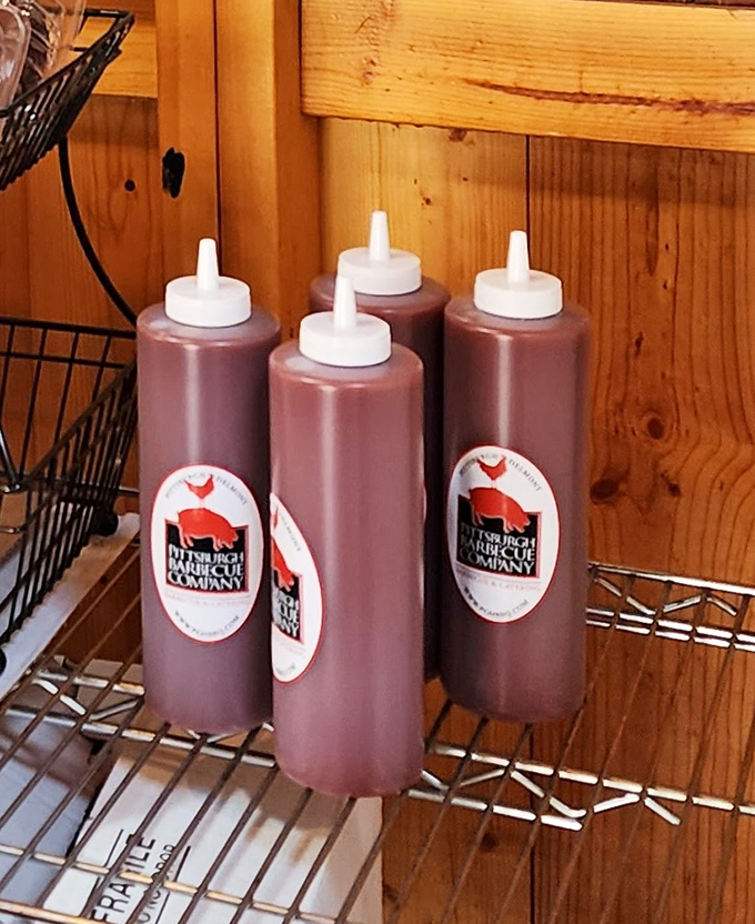 Squeeze bottles of house-made sauce standing at attention like delicious soldiers. These aren't just condiments—they're the final brushstrokes on a meaty masterpiece.