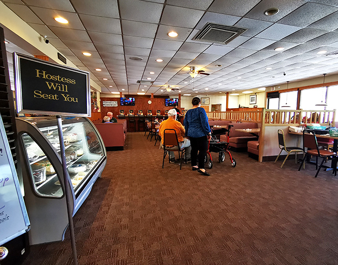 "Hostess Will Seat You" isn't just a sign, it's a promise that someone's about to guide you to your temporary happy place.