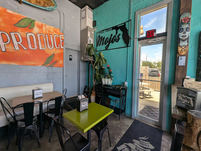 Lime-green tables pop against turquoise walls in this corner that feels like the Florida Keys crashed into a taco joint.