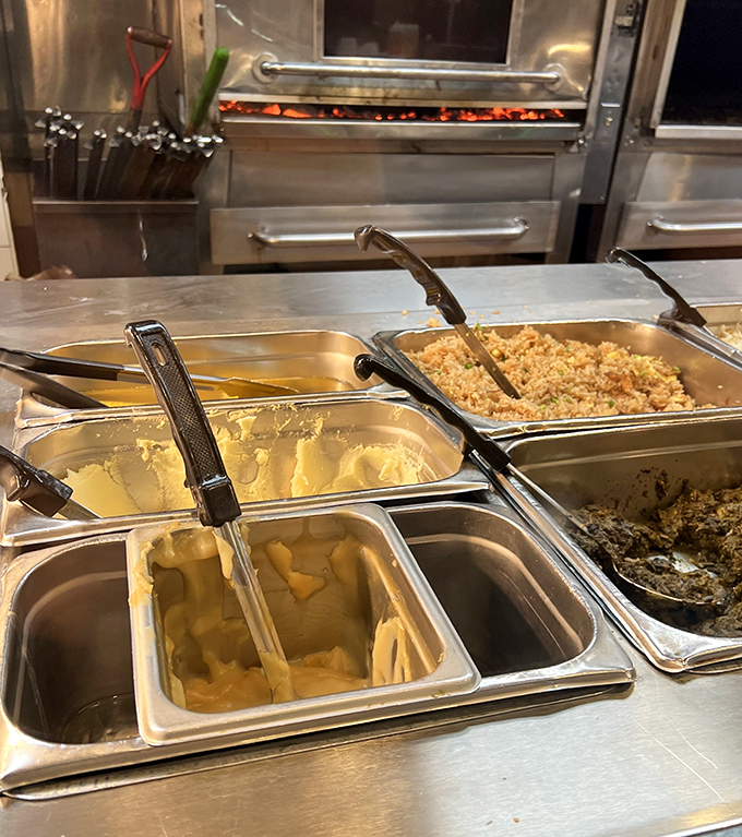 The sides station&mdash;where mashed potatoes, rice, and beans patiently wait to complete your plate and your happiness.