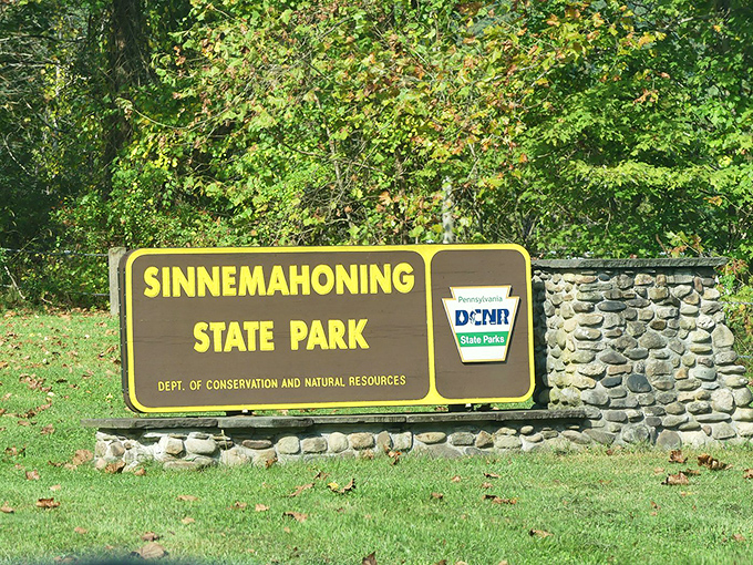 The entrance sign welcomes visitors with the promise of adventure, standing as the gateway between ordinary life and wilderness escape.