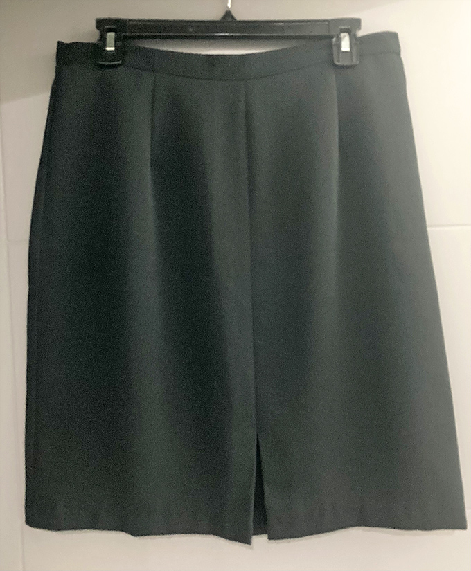 The perfect pencil skirt awaits its next boardroom. This classic black piece with front slit proves professional doesn't have to mean pricey.