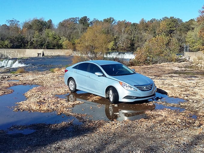A cautionary tale in four wheels&mdash;when parking near natural attractions, always respect posted boundaries or risk becoming an unintentional water feature yourself.