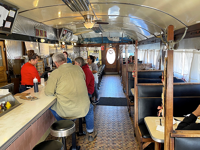 The classic diner layout&mdash;a runway of booths and counter seats where regulars have worn their own impressions into the vinyl.