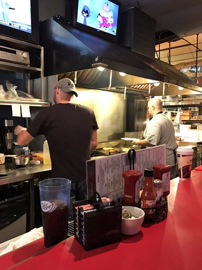 The kitchen ballet unfolds behind the counter, where skilled hands transform simple ingredients into plates of morning magic.