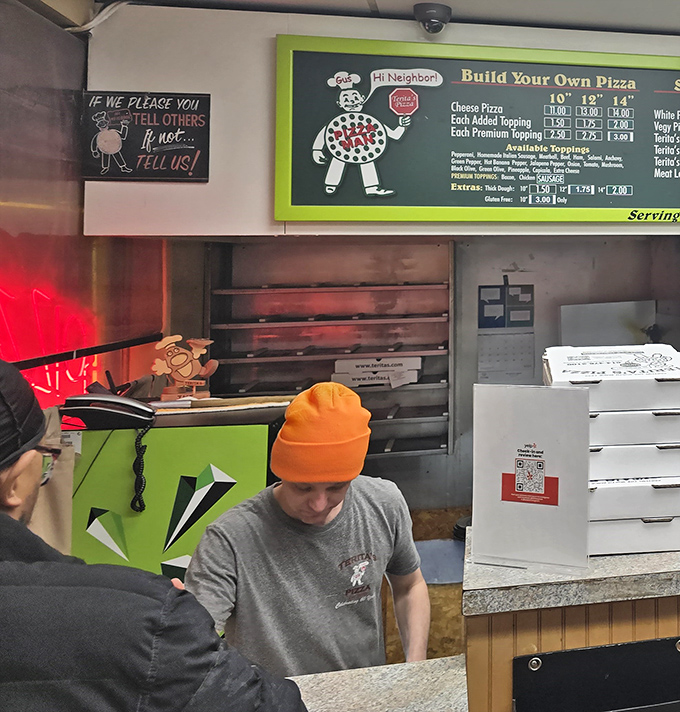 The menu board tells a story of culinary consistency &ndash; specialty pizzas that have earned their place through decades of customer loyalty.