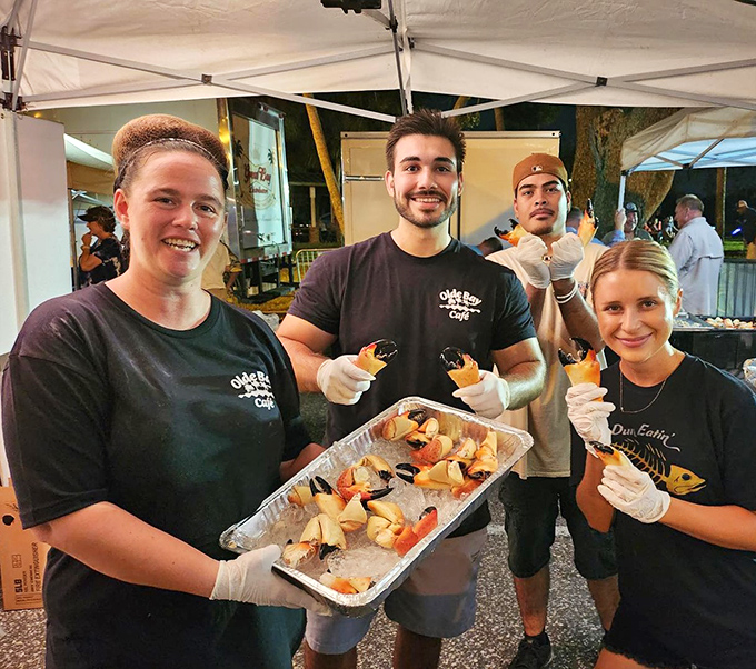 The staff proudly displaying their seafood bounty. These are the faces behind "caught fresh this morning" actually meaning something.