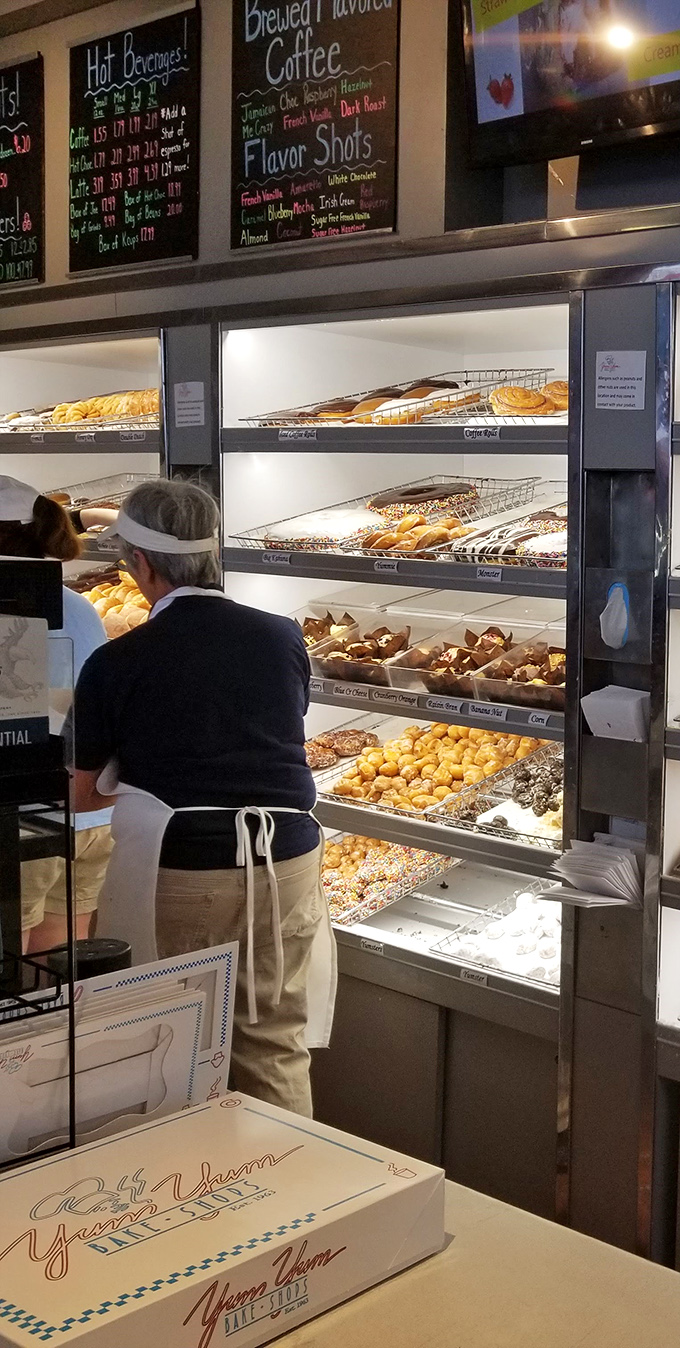 Behind every great donut is a dedicated baker, crafting joy one pastry at a time with practiced hands and quiet dedication.