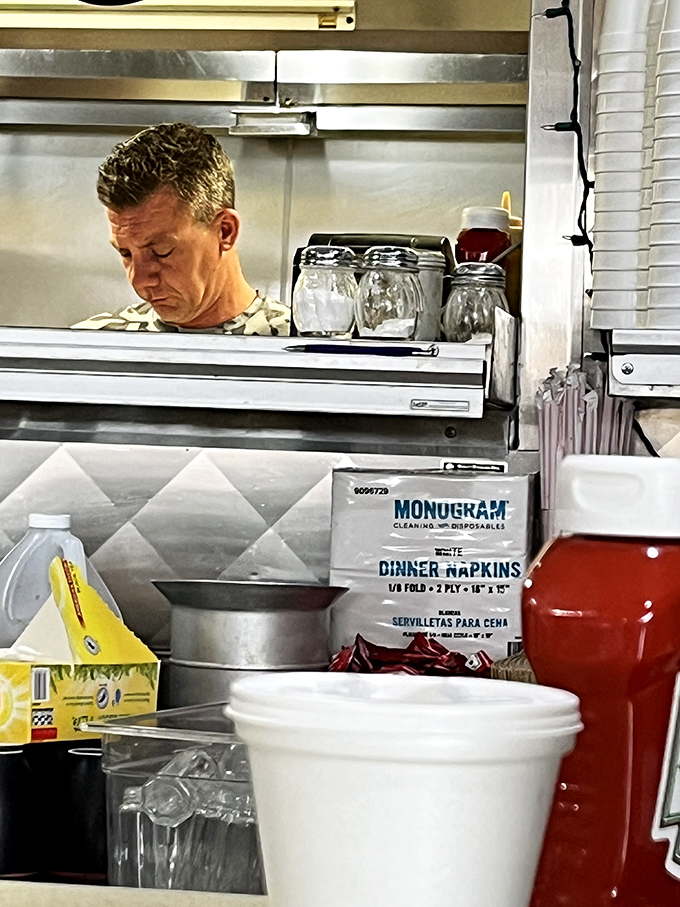 Where the magic happens – a glimpse into the kitchen where diner dreams come true. The concentration on that cook's face tells you he takes your breakfast seriously.