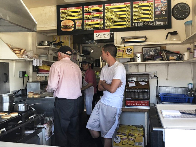 The kitchen crew works with the precision of seasoned professionals, a choreographed dance perfected over decades of burger-making.