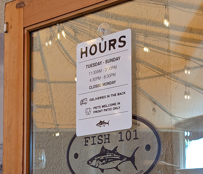 The hours sign tells you when to get your fish fix, with a friendly reminder that your four-legged friends are welcome on the patio.
