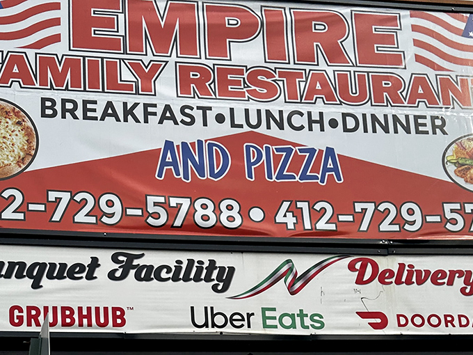 The sign doesn't whisper, it announces: "BREAKFAST &bull; LUNCH &bull; DINNER AND PIZZA"&mdash;covering all major food groups in bold, patriotic fashion.