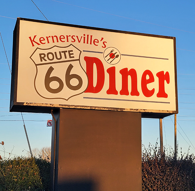 The roadside sign stands tall against Carolina blue skies, a beacon for hungry souls seeking comfort food salvation.