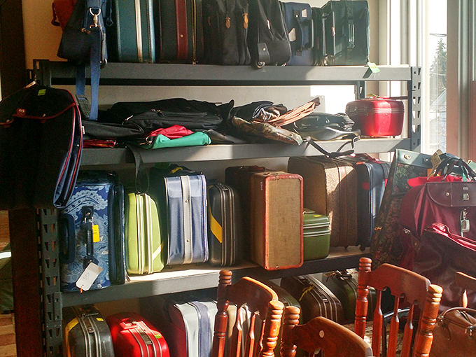 The suitcase collection stands like a museum of travel history&mdash;these weathered companions have stories to tell from road trips and family vacations long before rolling luggage.