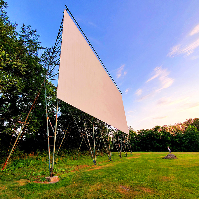 The big screen waits patiently for darkness, like a canvas ready for dreams.