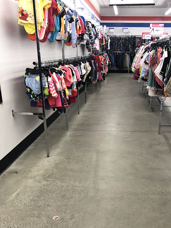 The children's clothing section: a rainbow of tiny garments that have barely been worn. Growing kids are a thrift store's best supplier.