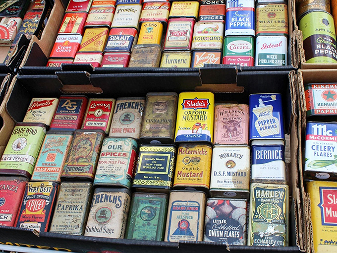 A collector's dream of vintage spice tins creates a time capsule of American kitchens past. Each colorful container represents flavors that seasoned decades of family meals.