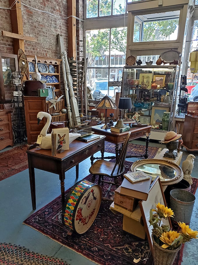 Exposed brick walls provide the perfect backdrop for this eclectic collection of vintage furnishings and decorative treasures.