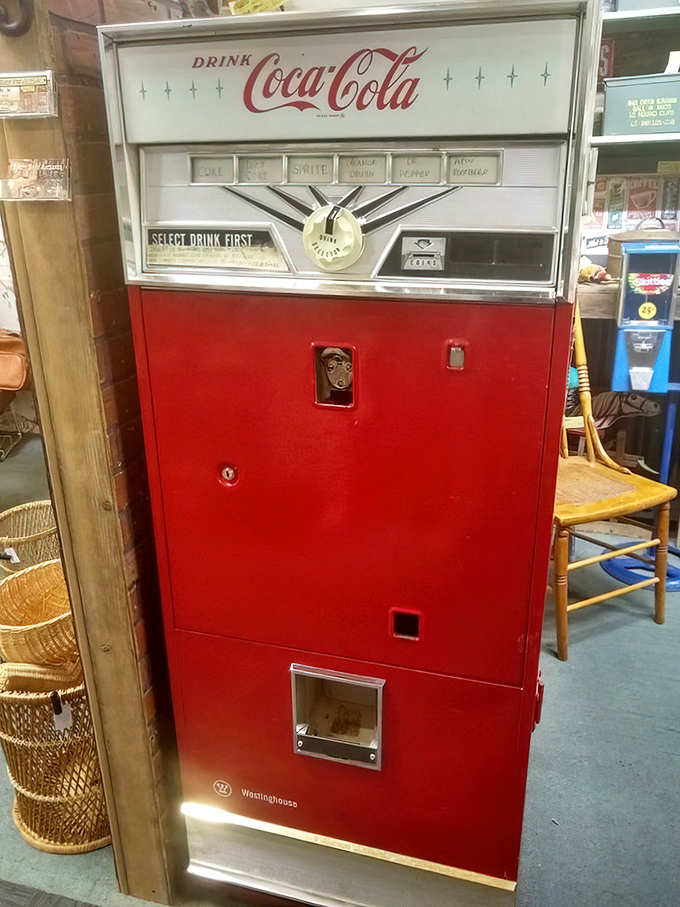 The classic Coca-Cola machine stands as a sentinel of simpler times. When a nickel bought happiness and glass bottles were king.