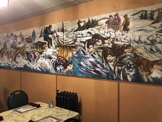 A dramatic mural depicting northwoods heritage&mdash;dogs, sleds, and snow creating the perfect backdrop for warm conversations over hot food.