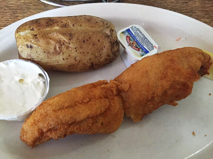 A perfectly golden walleye fillet with a baked potato on the side&mdash;Midwest lake-to-plate perfection that needs nothing more than a squeeze of lemon.