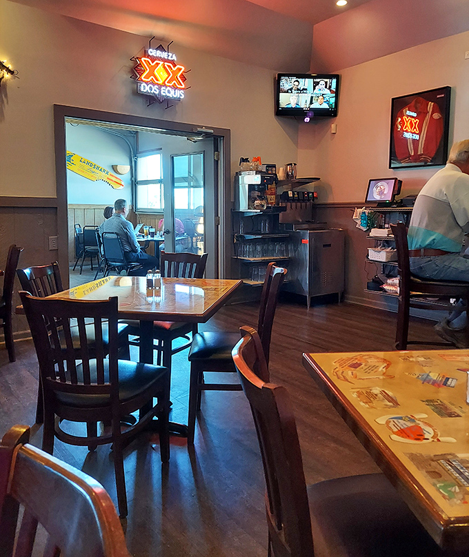 The separate dining section offers a slightly quieter experience, though the Dos Equis sign reminds you that interesting meals happen to those who venture inside.