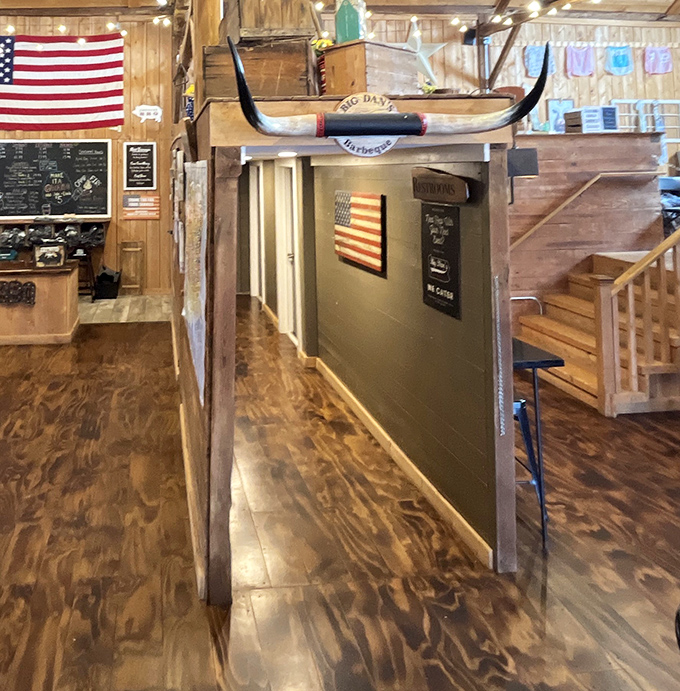 That longhorn mounted above the hallway isn’t just decoration—it’s your warning that even the restrooms carry the primal, smoky spirit of the place.