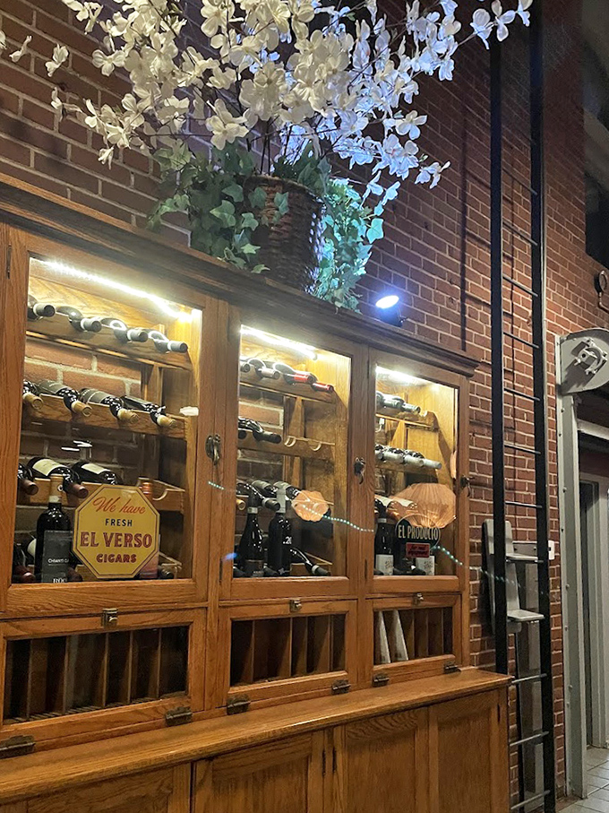 Wine bottles standing at attention behind elegant wooden cabinetry—liquid treasures waiting for the perfect pairing moment.