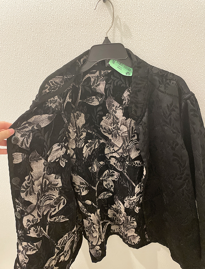 Floral elegance hanging in wait. This vintage jacket could transform someone from "just grabbing coffee" to "making an entrance" for less than lunch money.