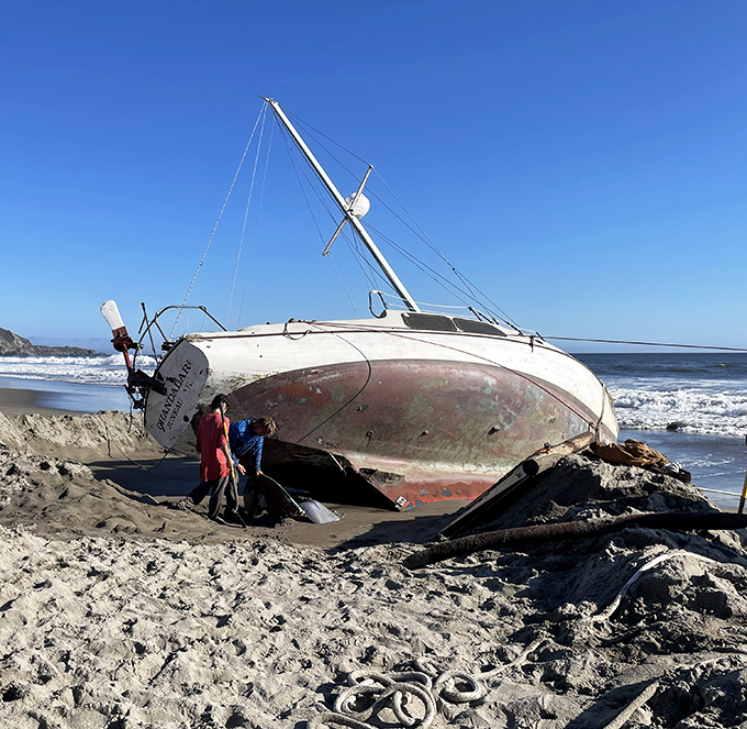 Another maritime casualty rests on the beach. This sailboat's racing days are over, but it's winning the photogenic contest.