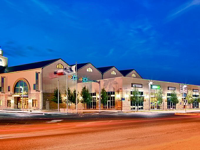 The vibrant lights of downtown Brownsville shine against the evening sky, with modern architecture and local pride giving the city charm.