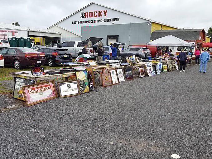 Vintage advertising gold! Beer signs and framed memorabilia lean against a building, waiting for collectors to discover them at Leighty's Outdoor Flea Market.