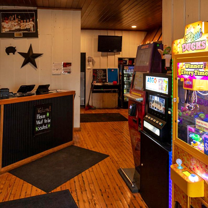 The host stand says "Please Wait to be Seated," but what it really means is "Prepare for a meal worth remembering." Gaming machines add local charm.