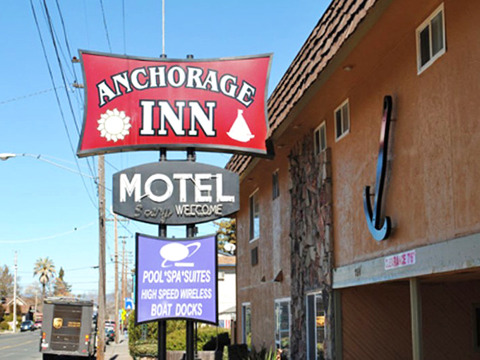 The Anchorage Inn's vintage sign promises boat docks and pool spas&mdash;a throwback to vacations when "amenities" meant actual fun, not tiny shampoo bottles.