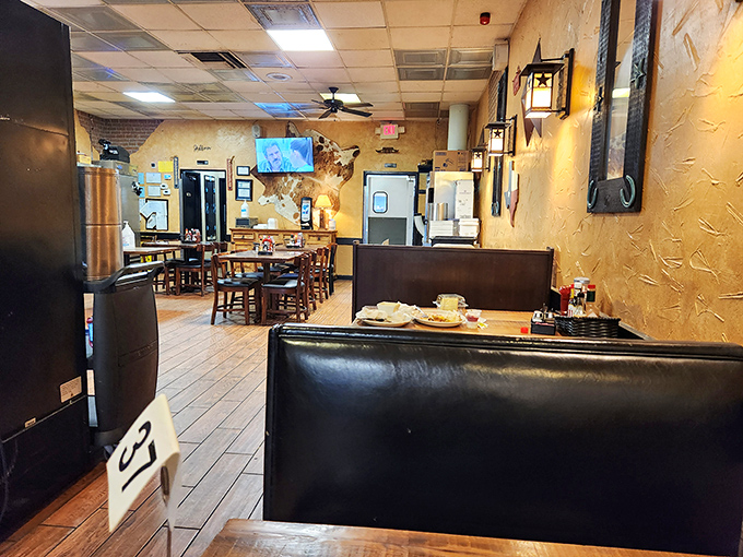 Leather booths that have cradled generations of happy diners, under the watchful gaze of Texas-themed wall art.