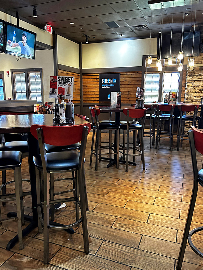 High-top tables and modern lighting create the perfect casual atmosphere for enjoying everything from wings to whiskey.