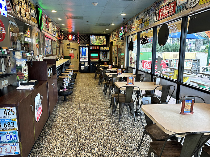 A narrow slice of pizza paradise where every inch of wall space tells a story. The terrazzo floor has seen generations of happy diners.