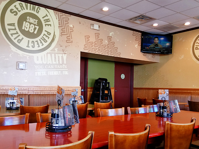 Warm wood tones and comfortable seating create the perfect backdrop for the serious business of pizza enjoyment.