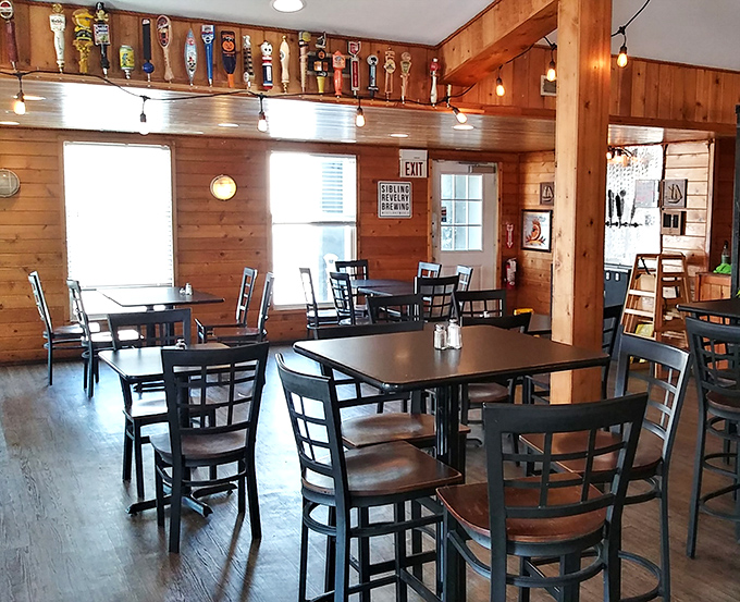 Beer tap handles line the ceiling like trophies, while natural light pours through windows that frame Lake Erie's beauty.