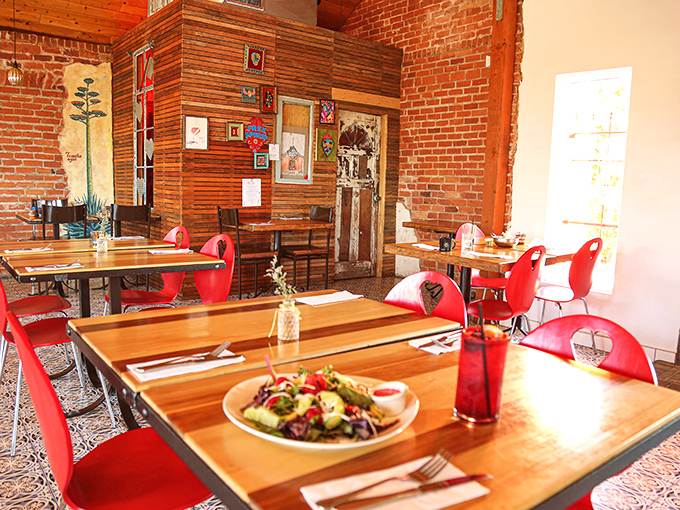 Red chairs pop against wooden tables and exposed brick walls, creating a space that's both energetic and intimate&mdash;like dinner with your liveliest friends.